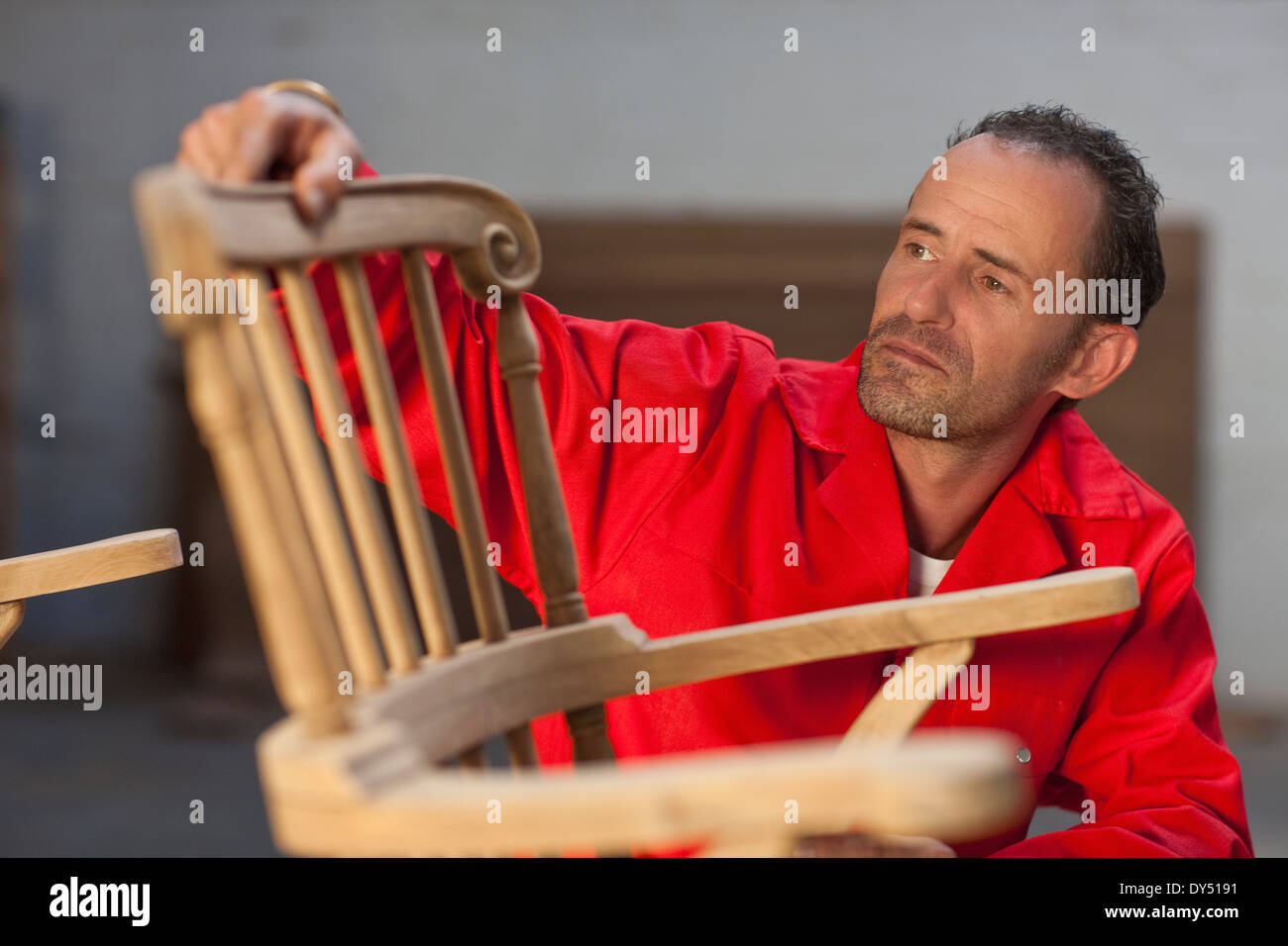 Carpenter working on chair Stock Photo - Alamy