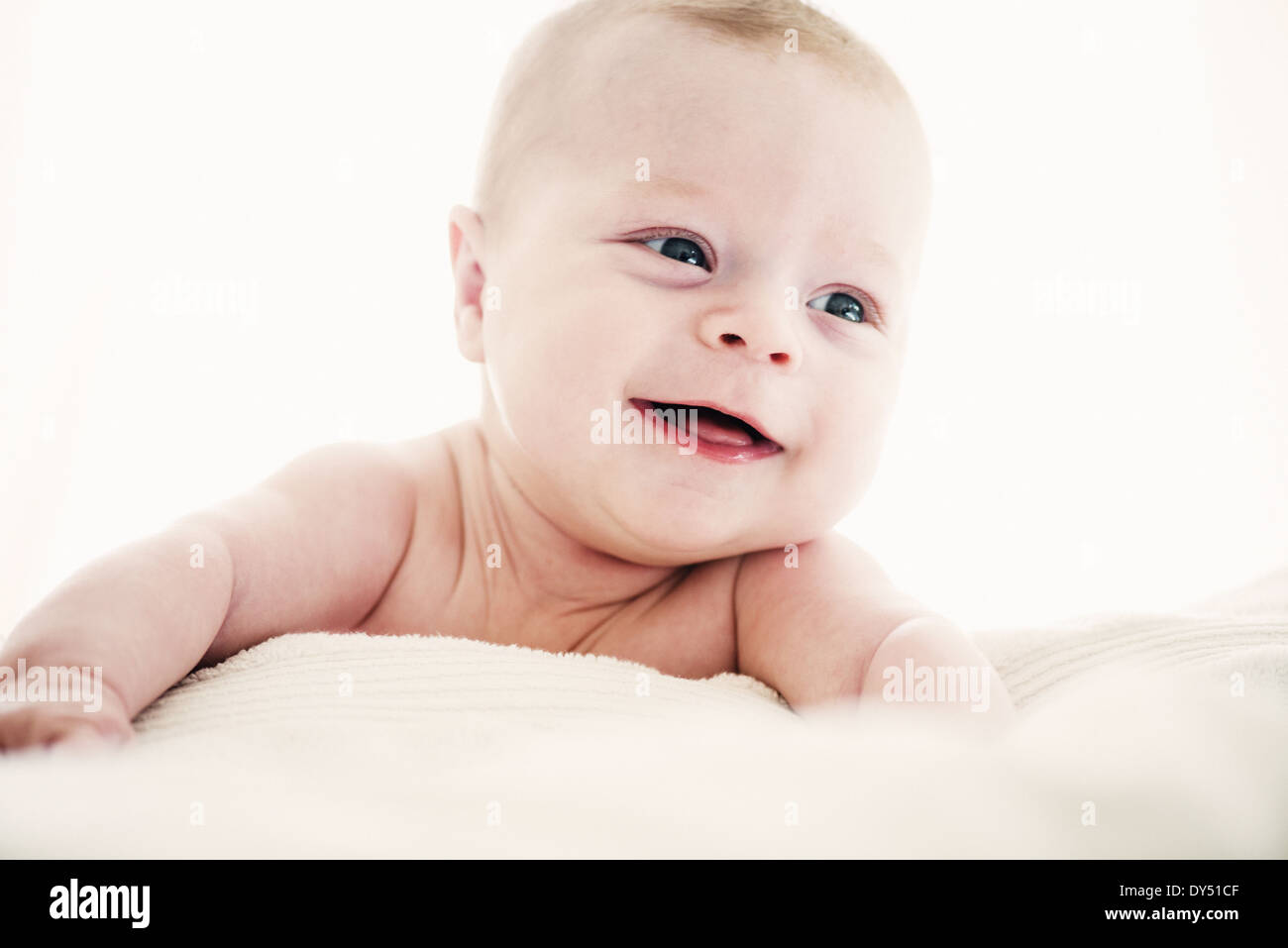 Portrait of smiling baby boy lying on front Stock Photo - Alamy