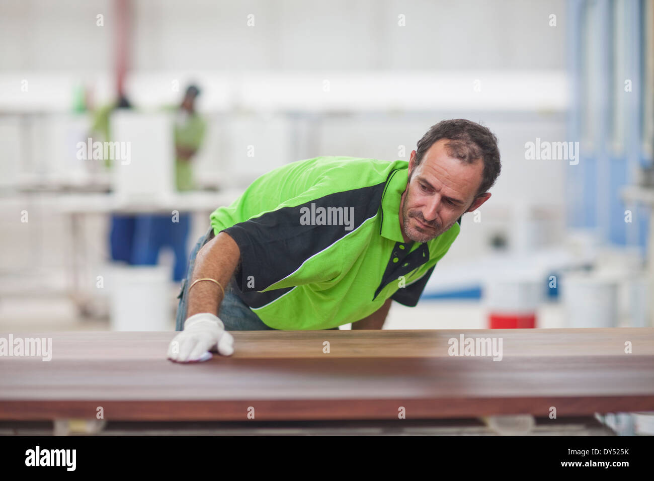 Carpenter checking quality of wood in workshop Stock Photo - Alamy