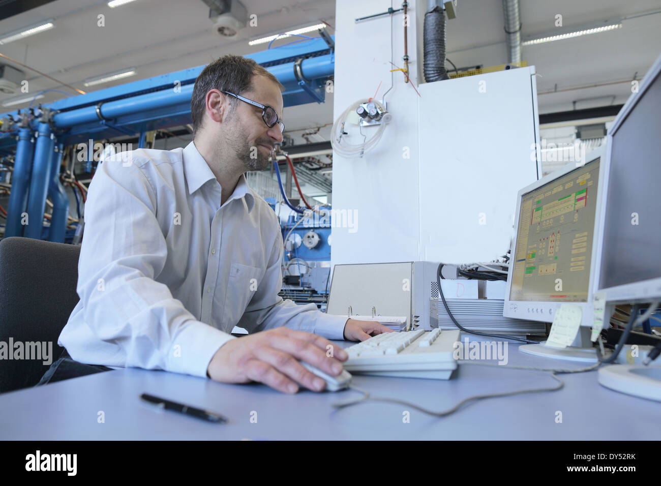 Manager monitoring information on computer Stock Photo - Alamy