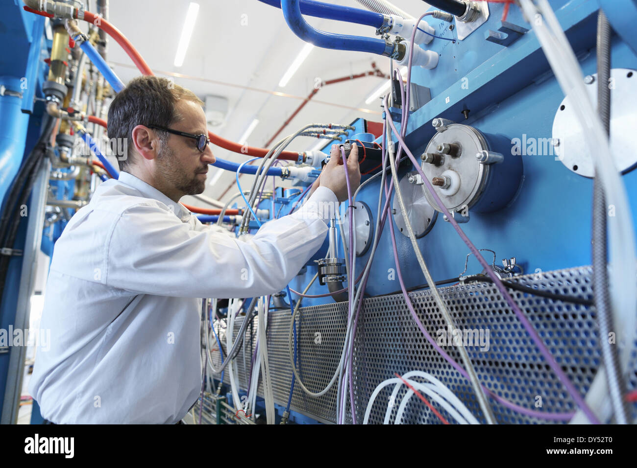 Manager checking industrial equipment Stock Photo - Alamy