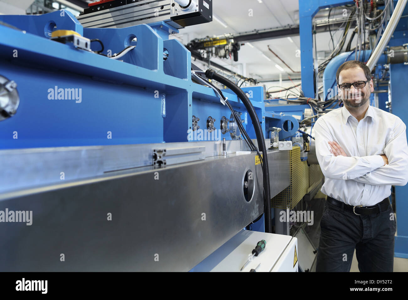 Portrait of manager and machinery in workshop Stock Photo - Alamy