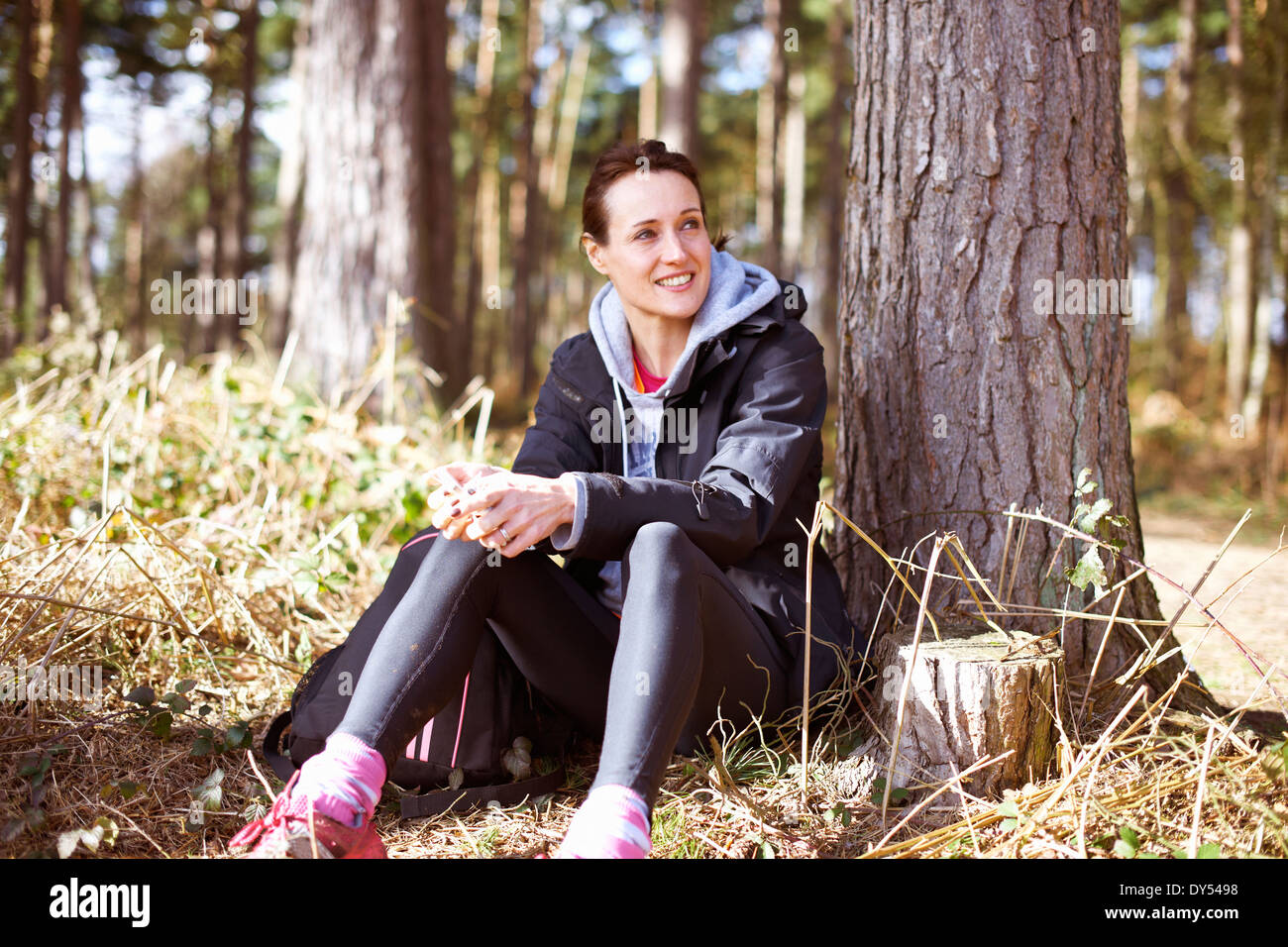 Mature woman taking a break in a forest Stock Photo - Alamy
