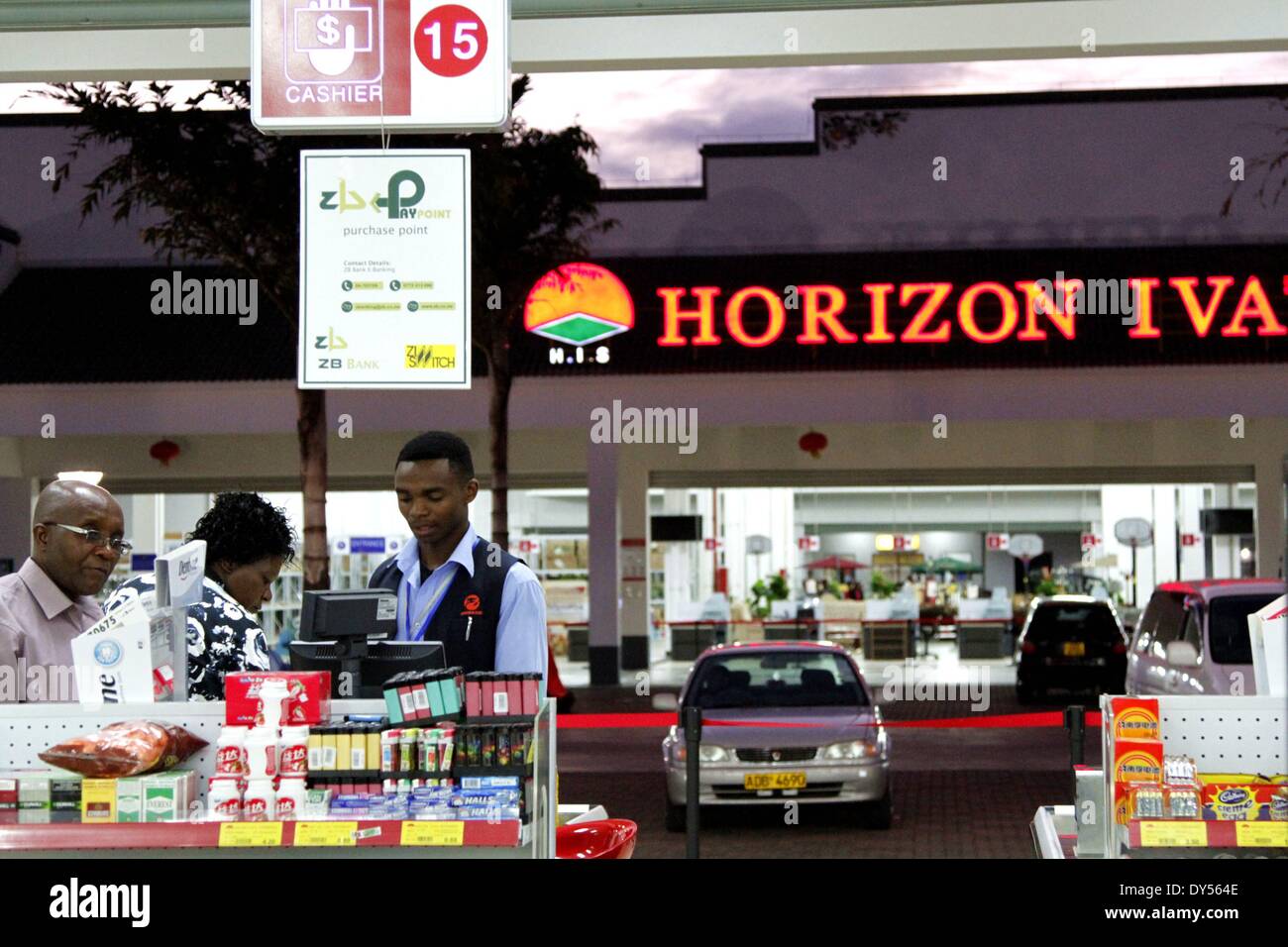 Harare, Zimbabwe. 6th Apr, 2014. Customers pay for their purchases at a ...