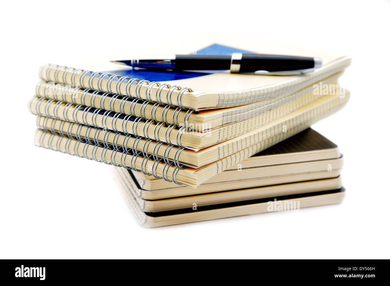 Pile of notebooks isolated on a white background Stock Photo - Alamy
