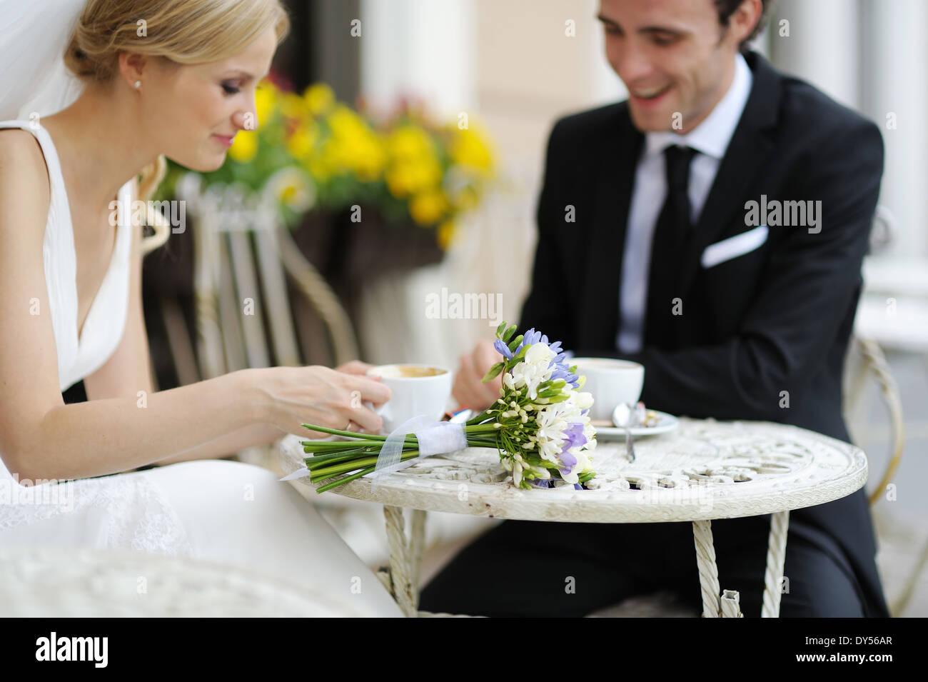 Wedding flowers on a table (bride and groom in a background Stock Photo ...