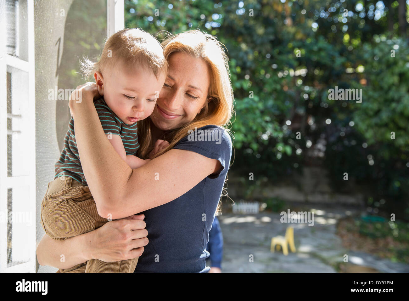 Mother hugging baby Stock Photo - Alamy
