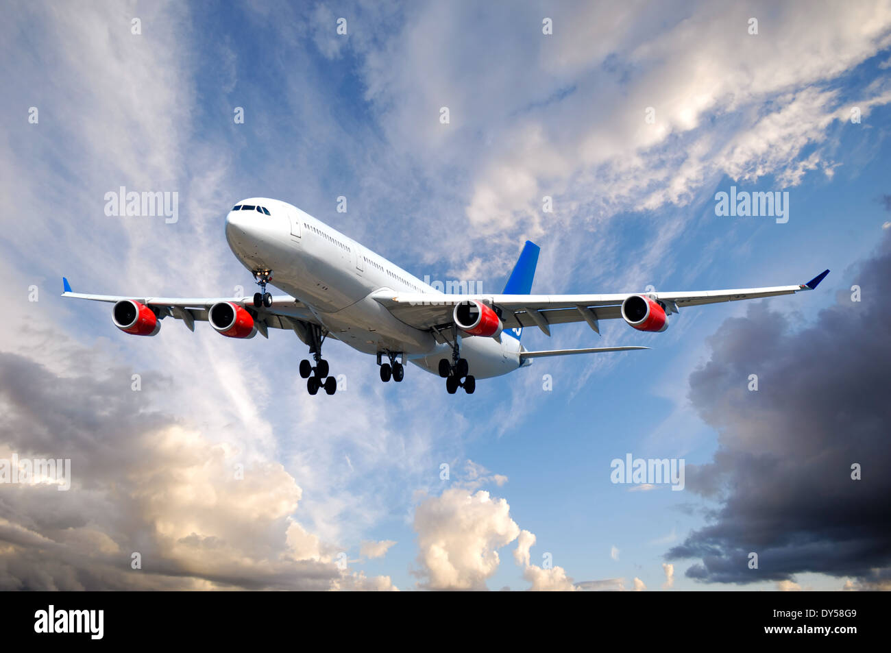 Plane is flying in the sky among light and dark clouds Stock Photo - Alamy