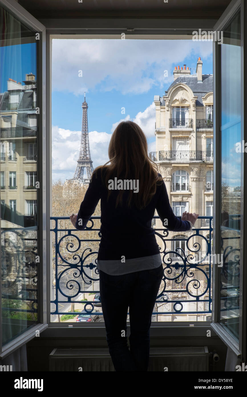 Woman looking at the Eiffel Tower, Paris, France, viewed through an ...