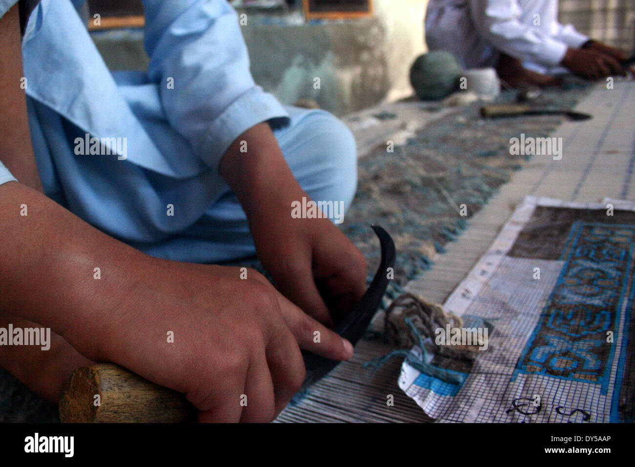 Peshawar. 7th Apr, 2014. A Pakistani boy crafts handmade carpets at a ...
