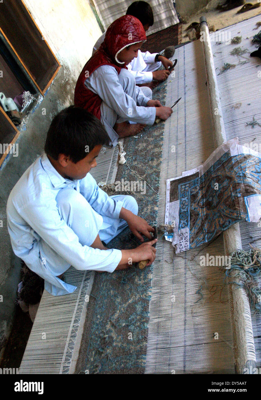 Peshawar. 7th Apr, 2014. Pakistani boys craft handmade carpets at a ...