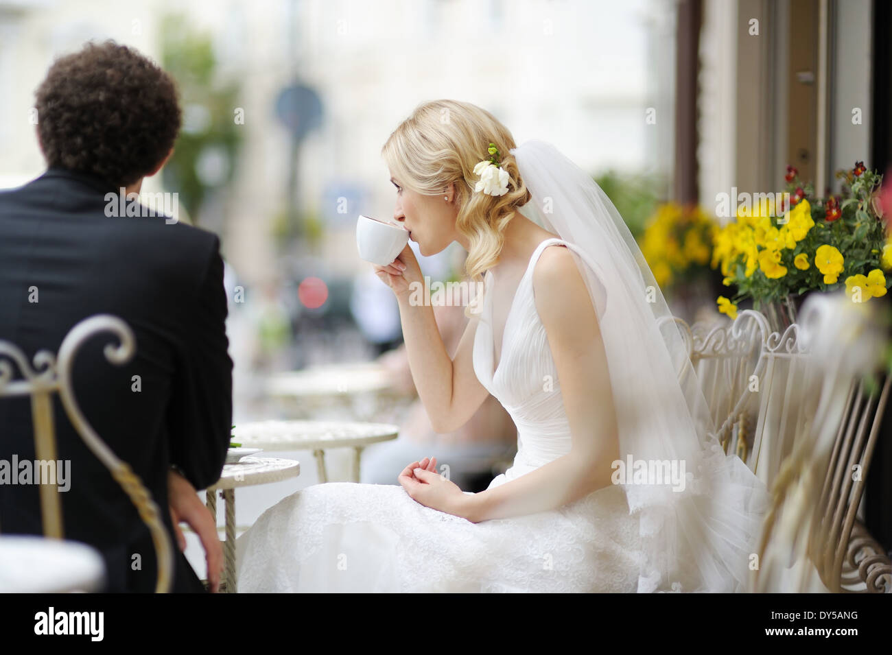 Bride and groom drinking coffee at an outdoor cafe Stock Photo - Alamy
