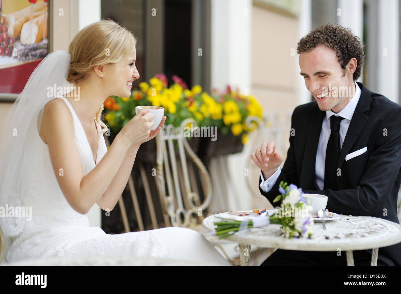 Bride and groom drinking coffee at an outdoor cafe Stock Photo - Alamy