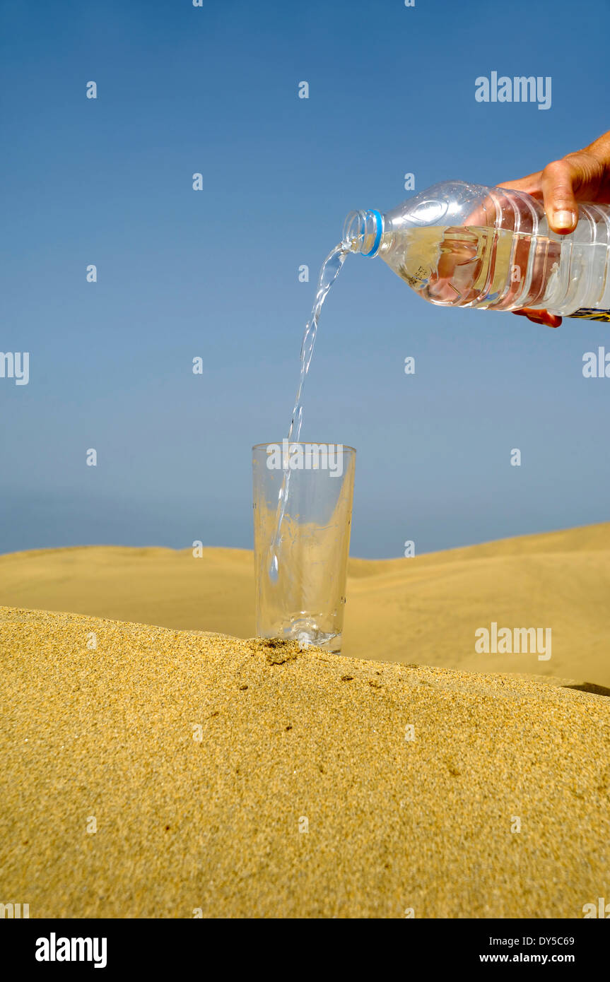 A glass of fresh water and bottle in a desert Stock Photo - Alamy
