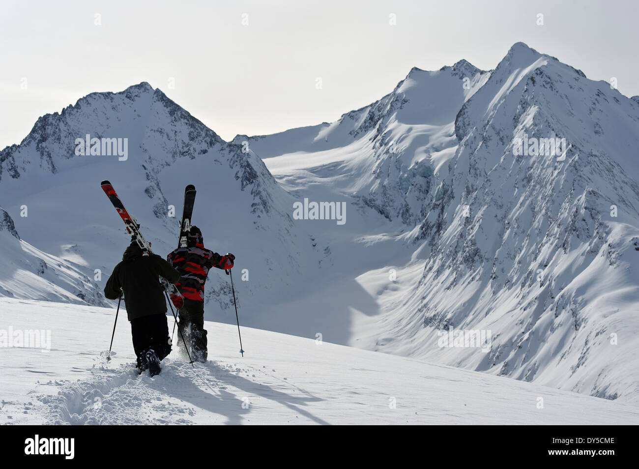 Two mid adult male skiers walking uphill, Obergurgl, Austria Stock ...