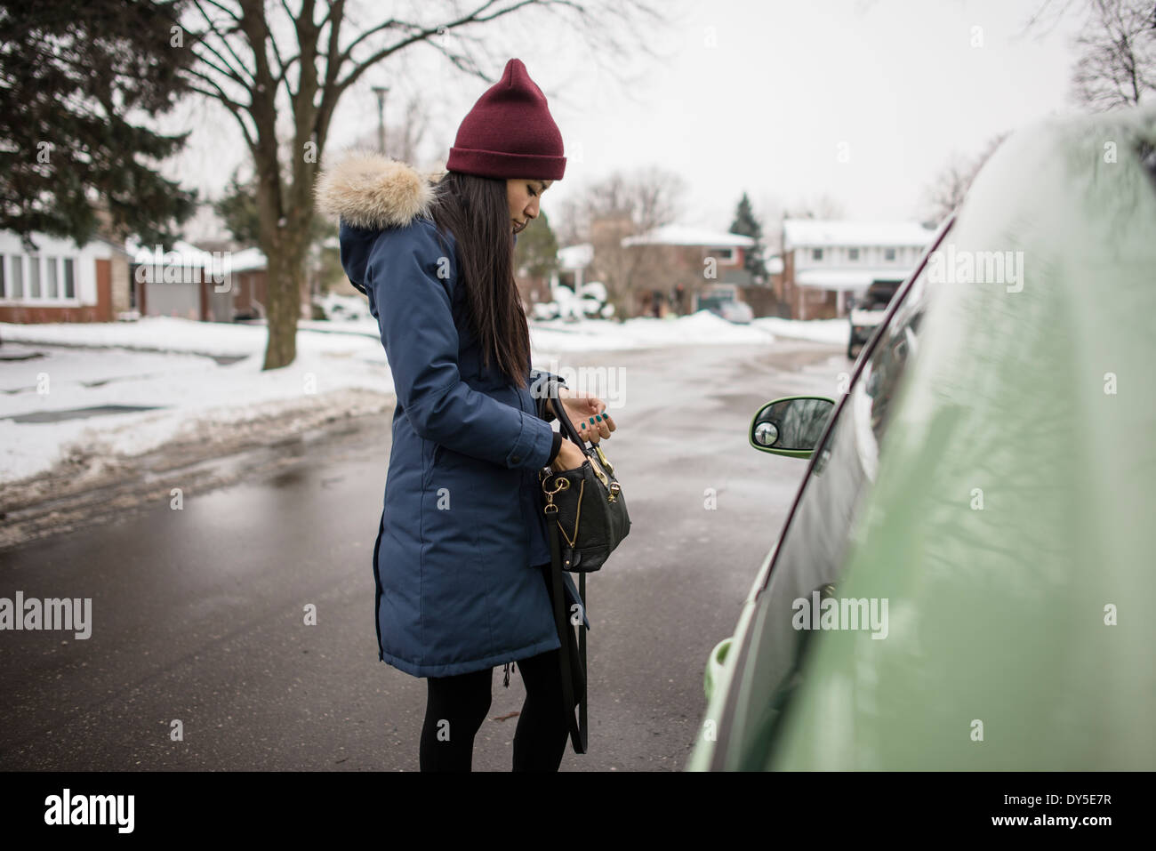 Young woman searching for car keys in her bag Stock Photo - Alamy