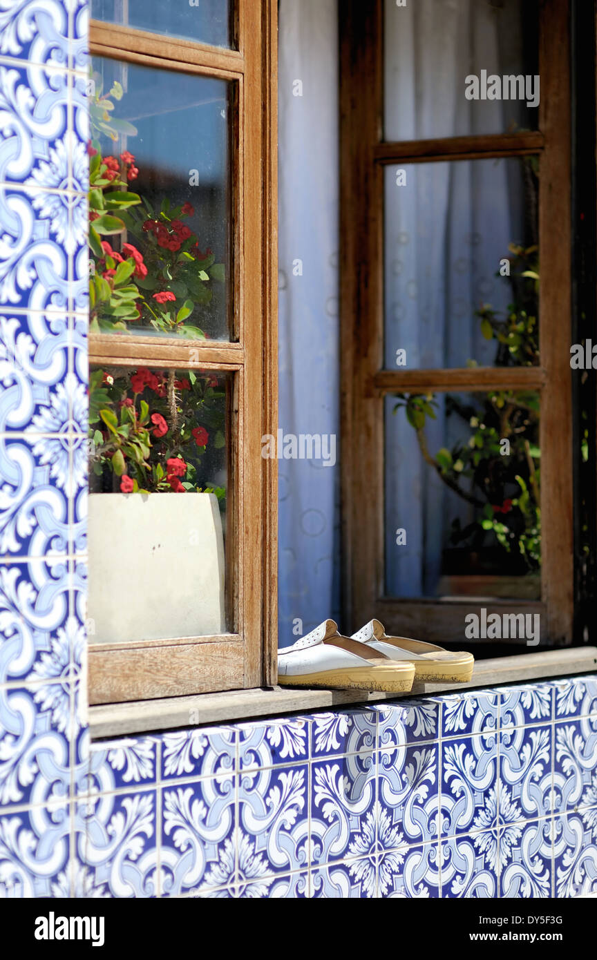 Old shoes on the decorated portuguese window Stock Photo - Alamy