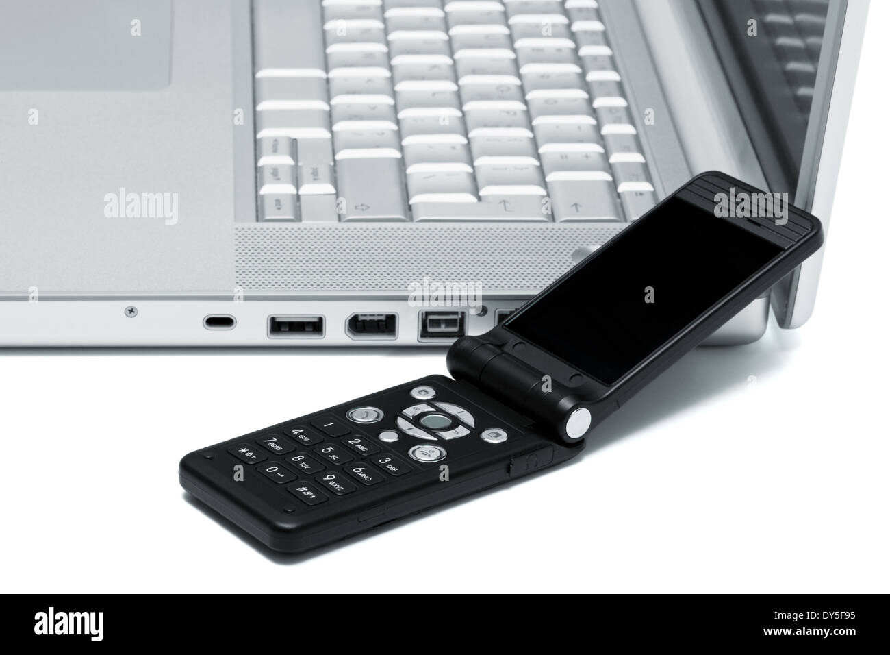 Mobile phone on the keyboard of a laptop Stock Photo - Alamy