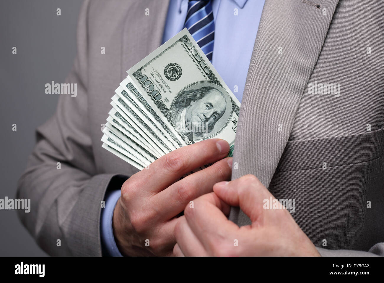 Business man putting money in hi-res stock photography and images - Alamy