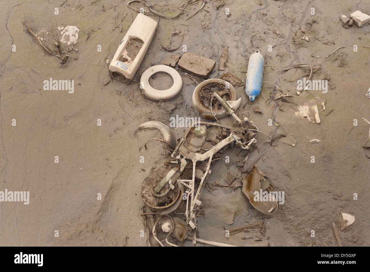 hidden discarded thrown away objects uncovered at low tide in estuary ...