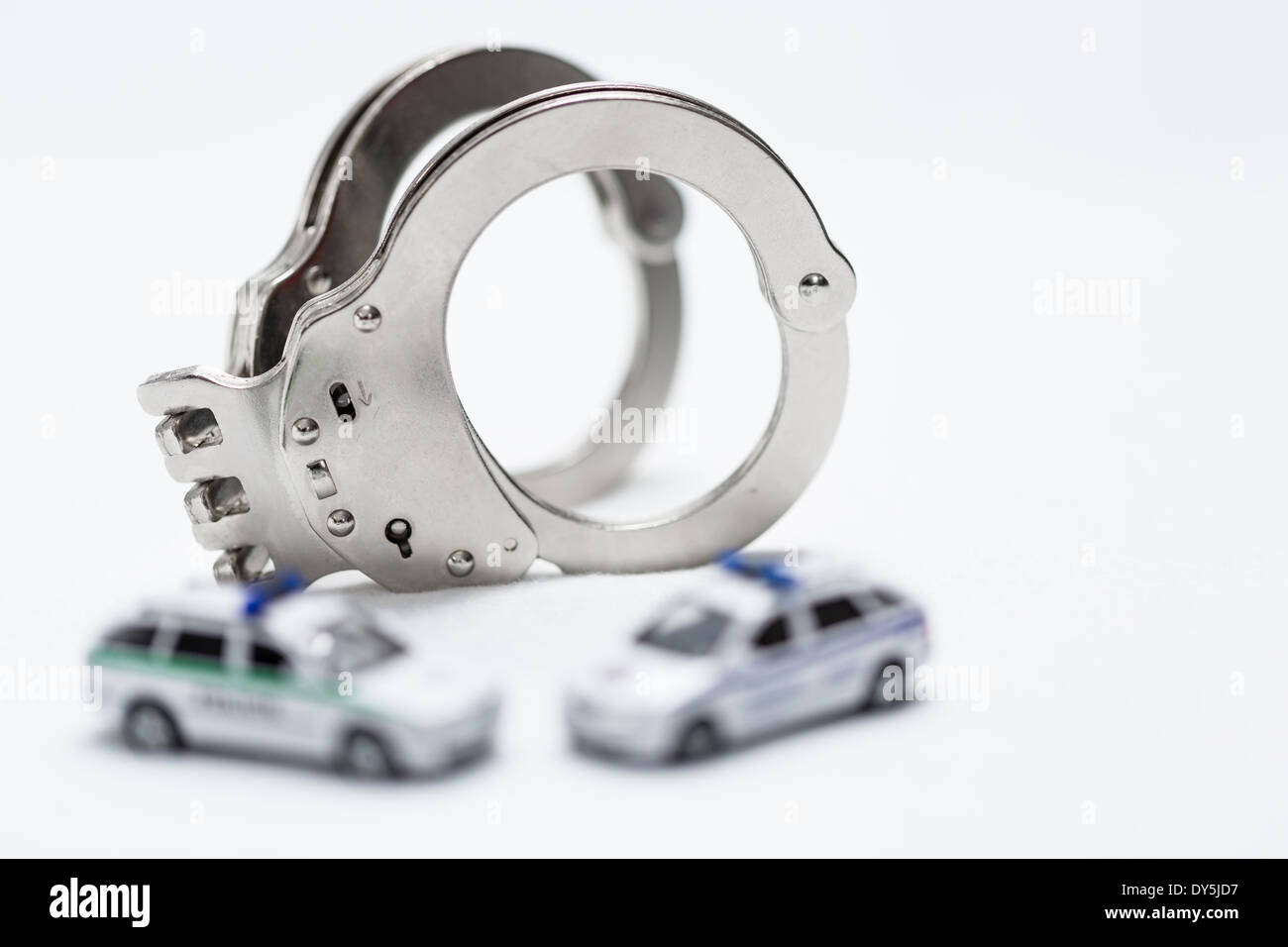 Shackles with models of police and city police car on white background ...