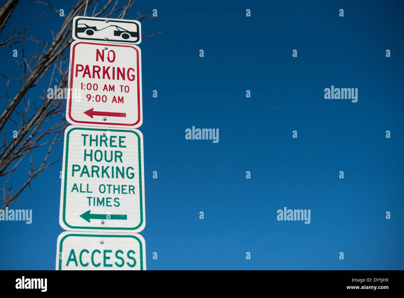 WASHINGTON DC — Multiple parking restriction signs are stacked ...