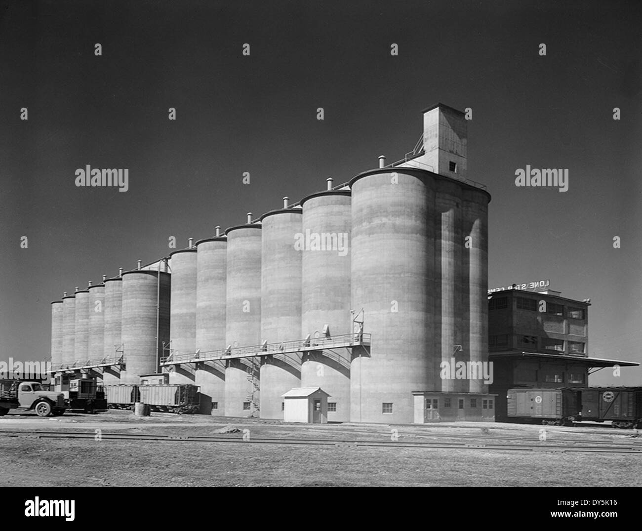 Trucks and cement silos at the Lone Star Cement Corporation’s ...