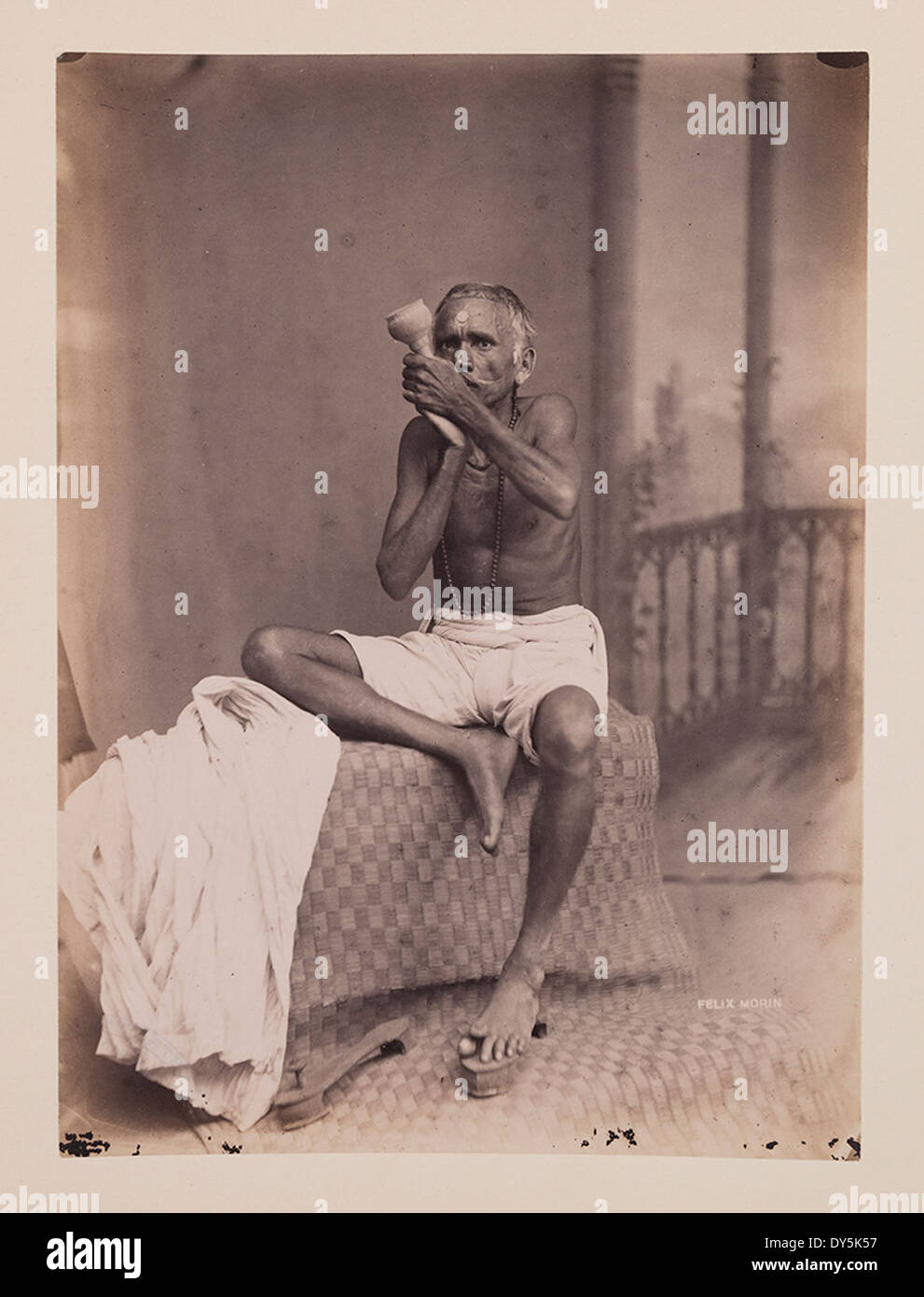 A portrait of an East Indian man smoking a pipe, representing cultural ...