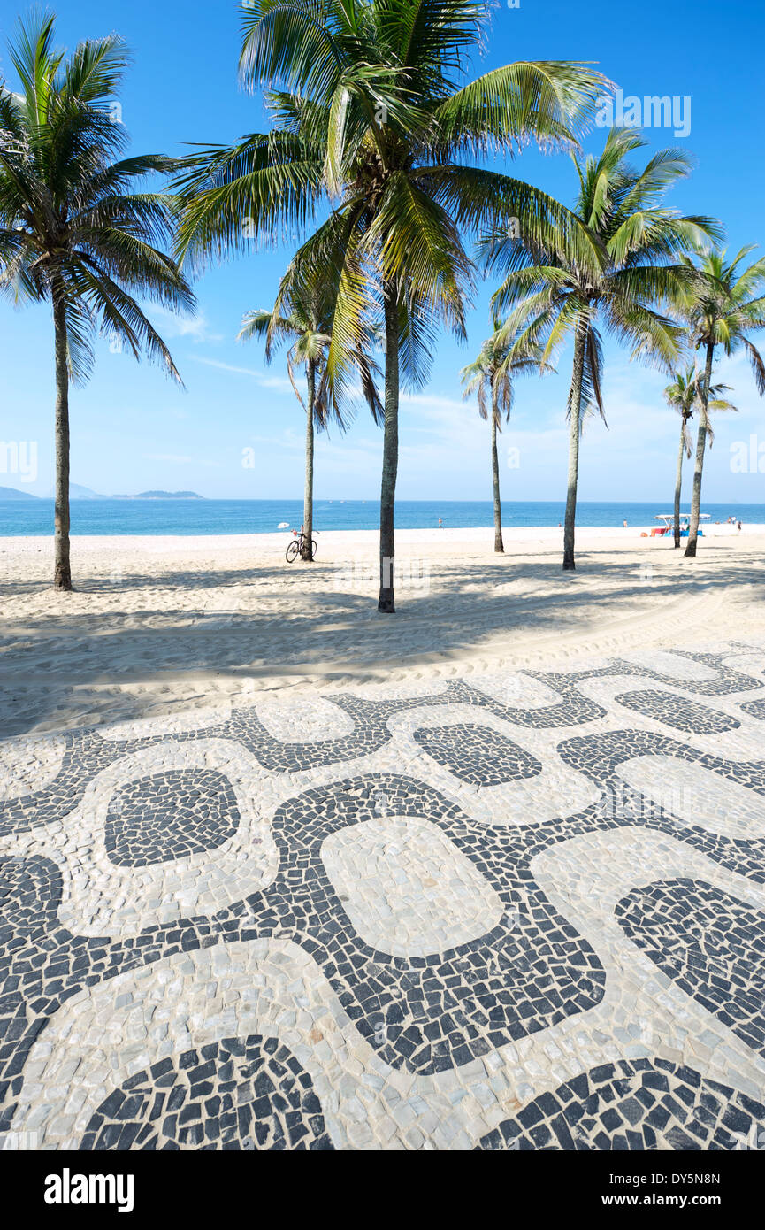 Classic view of Ipanema Beach Rio de Janeiro boardwalk with palm trees ...