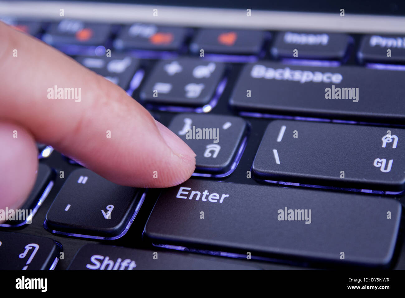 a finger is pushing the enter button Stock Photo - Alamy