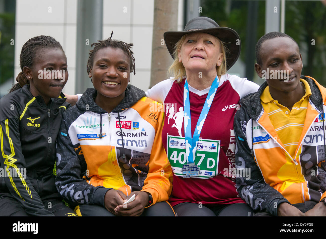 Kenyan marathon runners posing together with a older marathon run ...