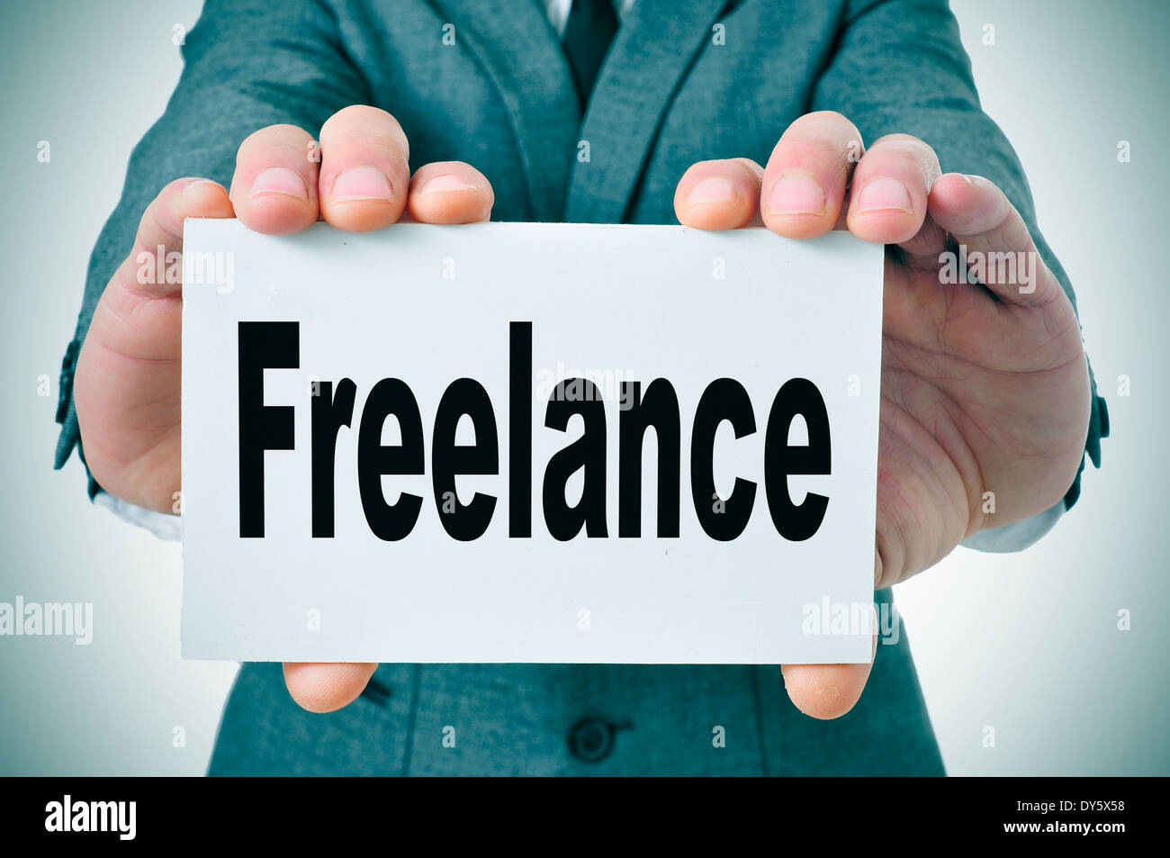 businessman showing a signboard with the word freelance written in it ...