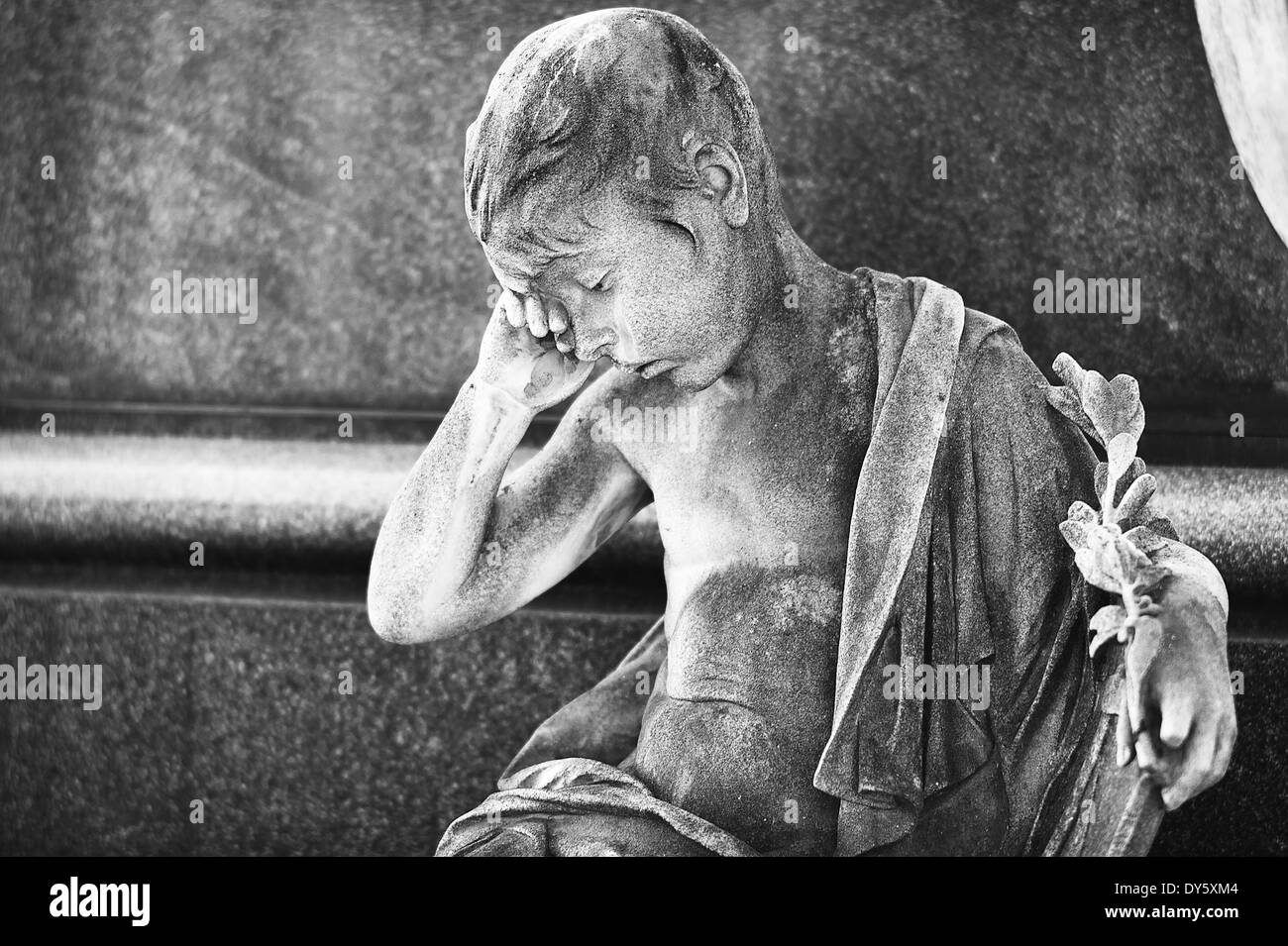 Boy statue crying at the Hietzinger cemetery, Vienna Austria. Black ...