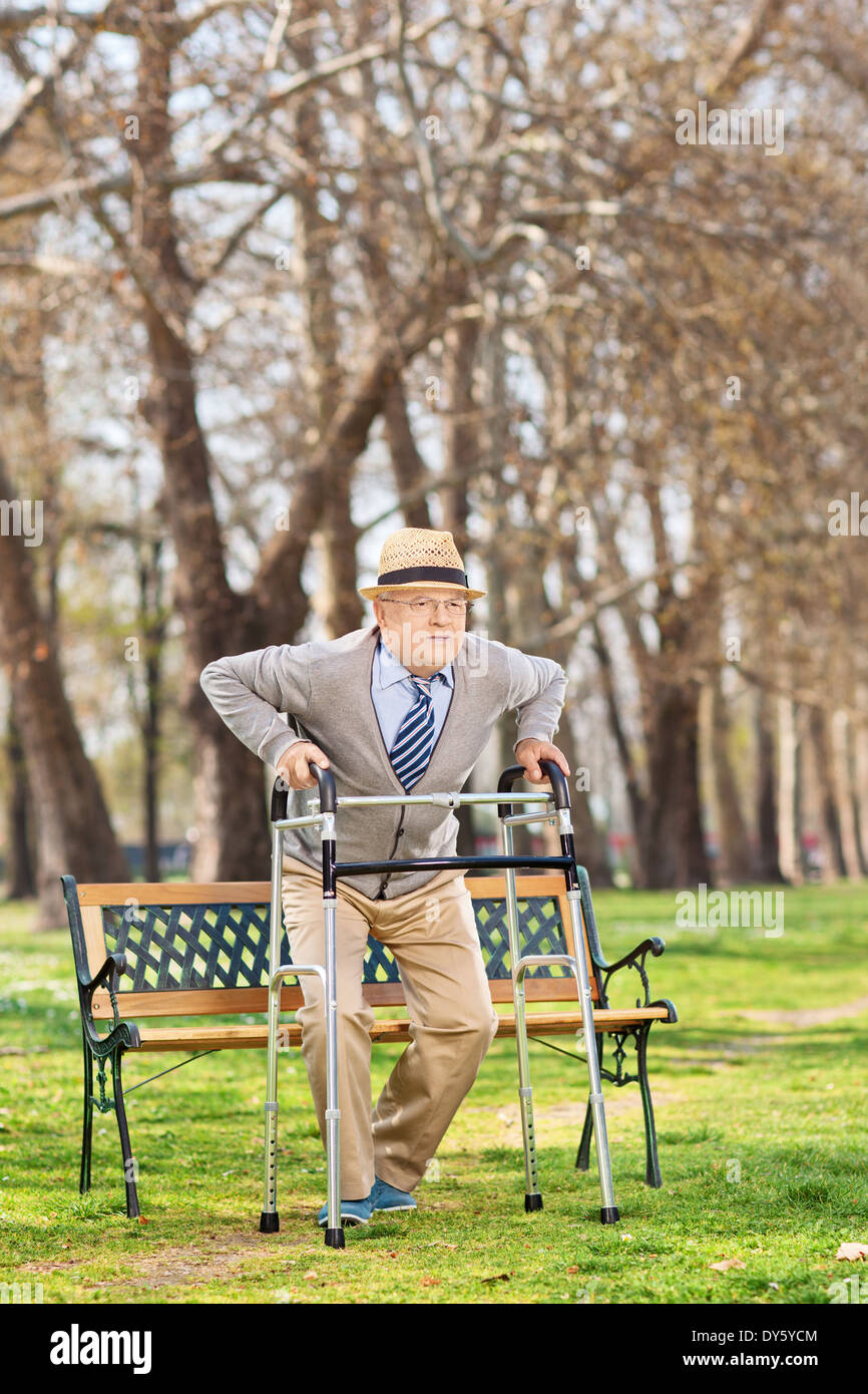 Sick old man standing up with walker outside Stock Photo - Alamy