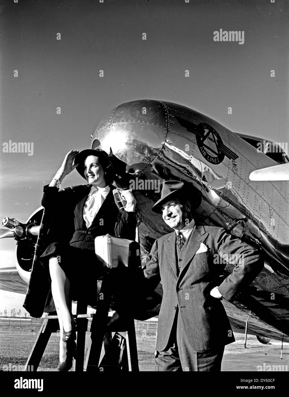 Two models pose in front of a Lockheed 10B Electra aircraft at Dallas ...
