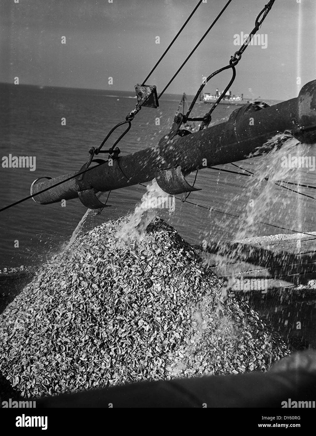 A dredge filling barge operated by the Houston Pipe Line Company is ...