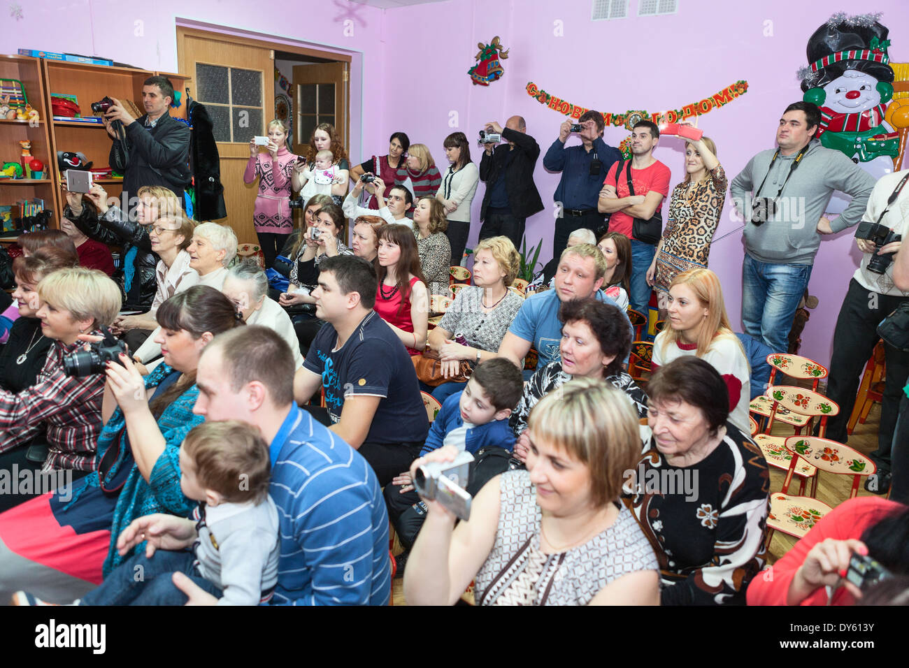 Parents looking at theater stage in kindergarten, Russia. Graduation ...