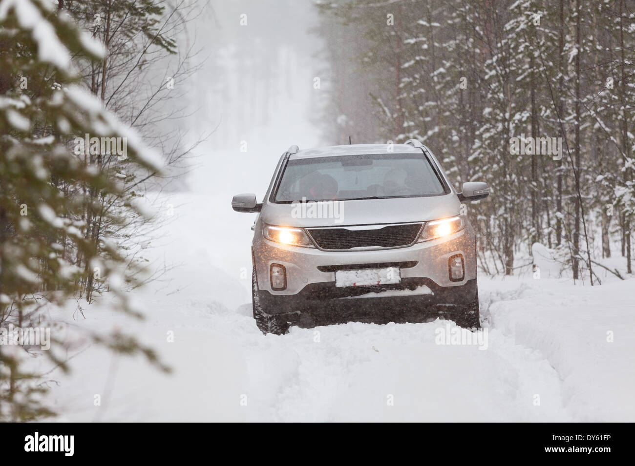 Offroad vehicle riding on snowy road, front view Stock Photo - Alamy