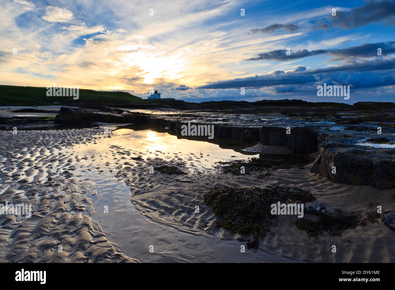 Summer sunset over Bamburgh beach lighthouse, Bamburgh, Northumberland ...