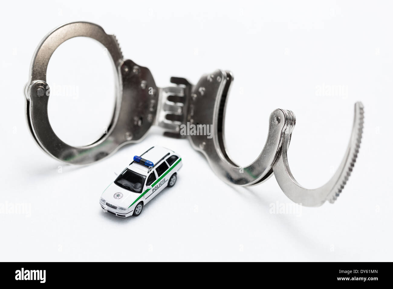 Shackles with model of police car on white background Stock Photo - Alamy