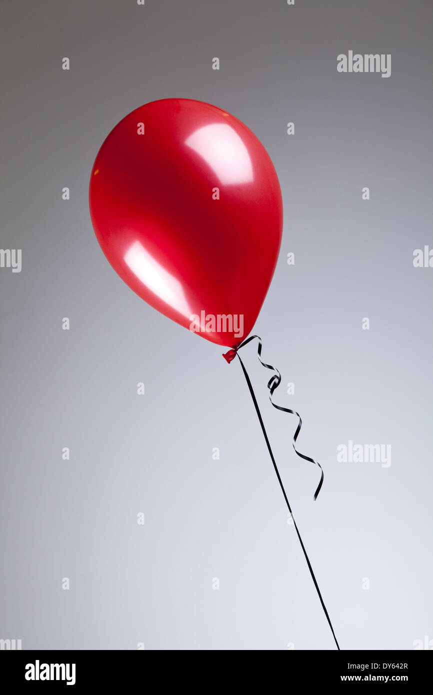 Shiny Red Balloons on a grey background Stock Photo - Alamy