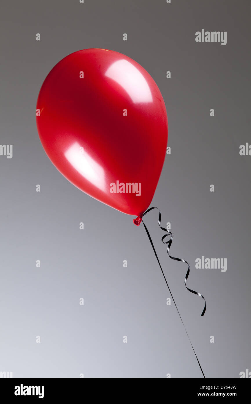 Shiny Red Balloons on a grey background Stock Photo - Alamy