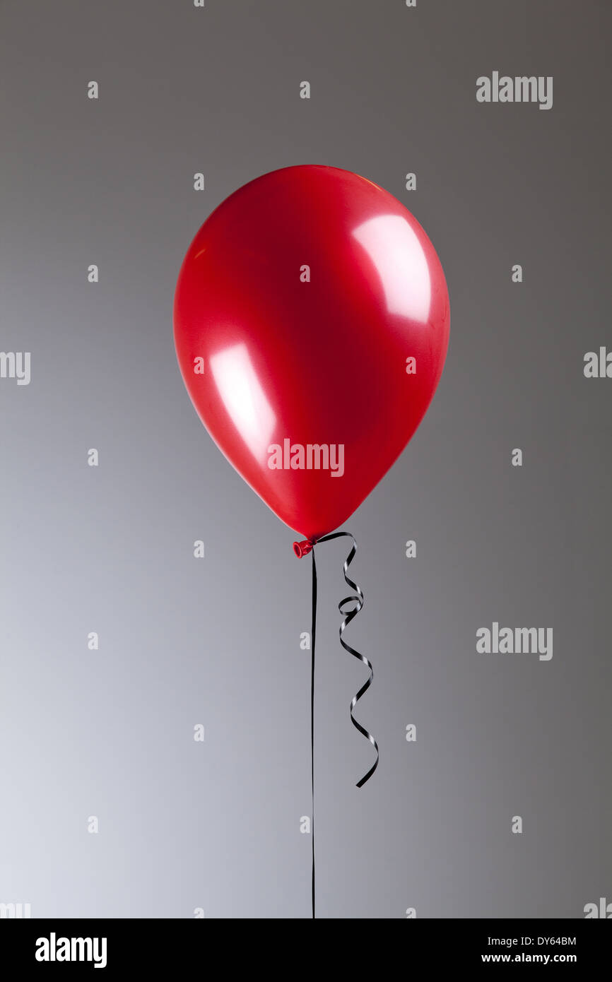 Shiny Red Balloons on a grey background Stock Photo - Alamy