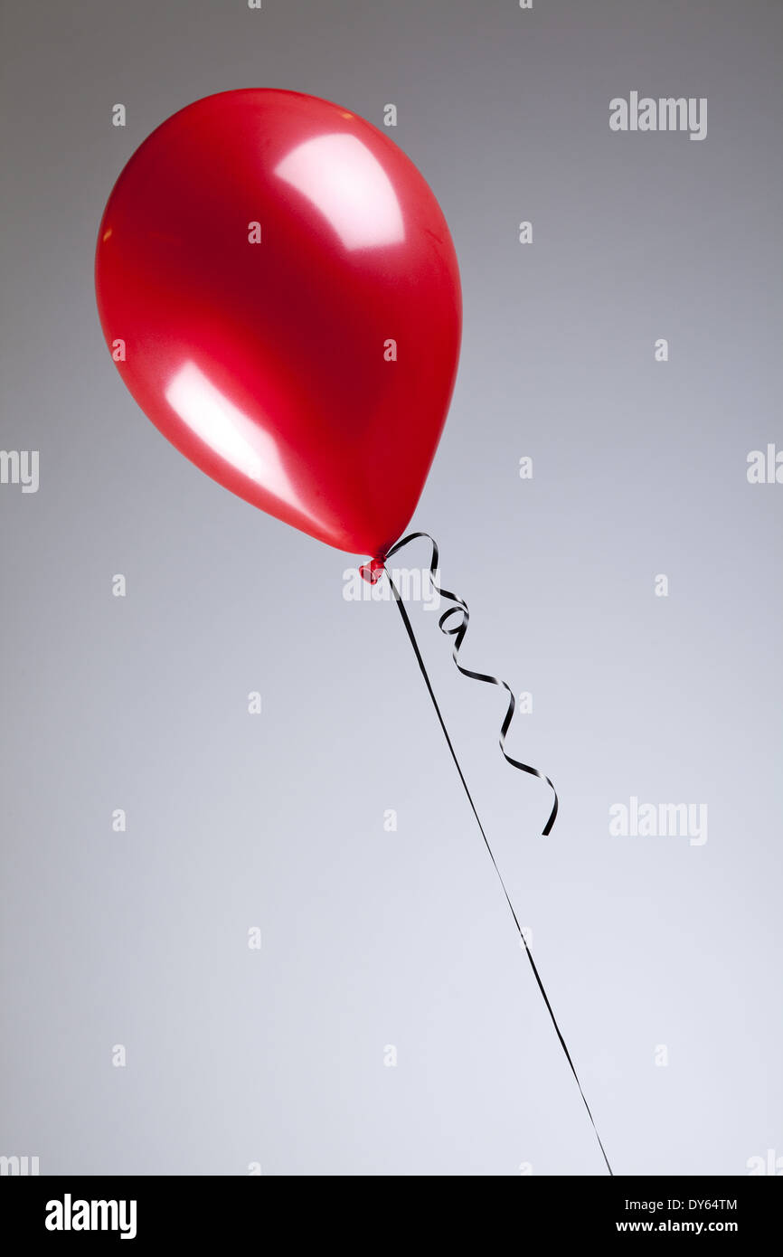 Shiny Red Balloons on a grey background Stock Photo - Alamy