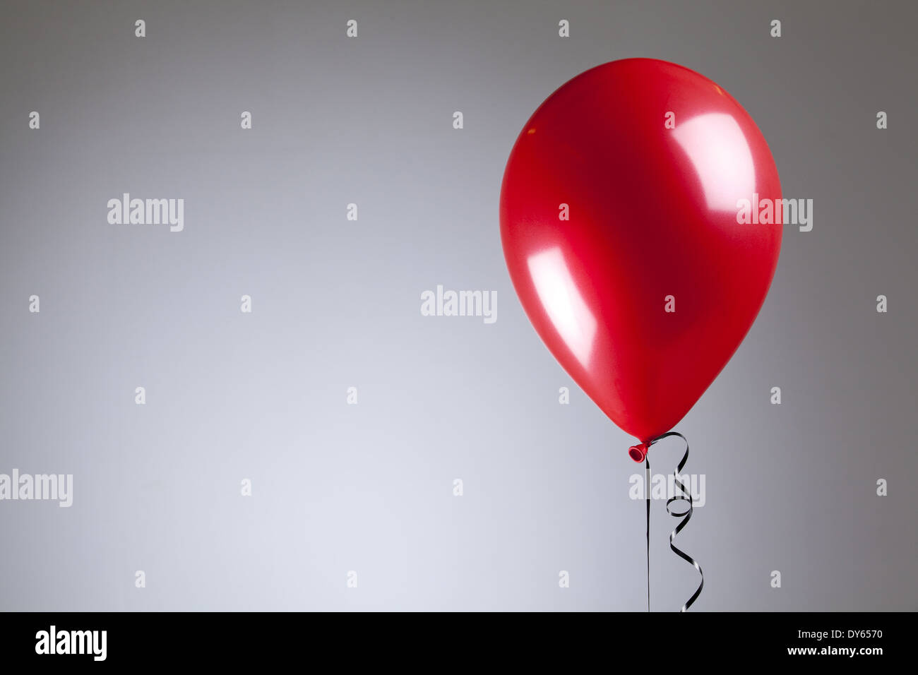 Shiny Red Balloons on a grey background Stock Photo - Alamy