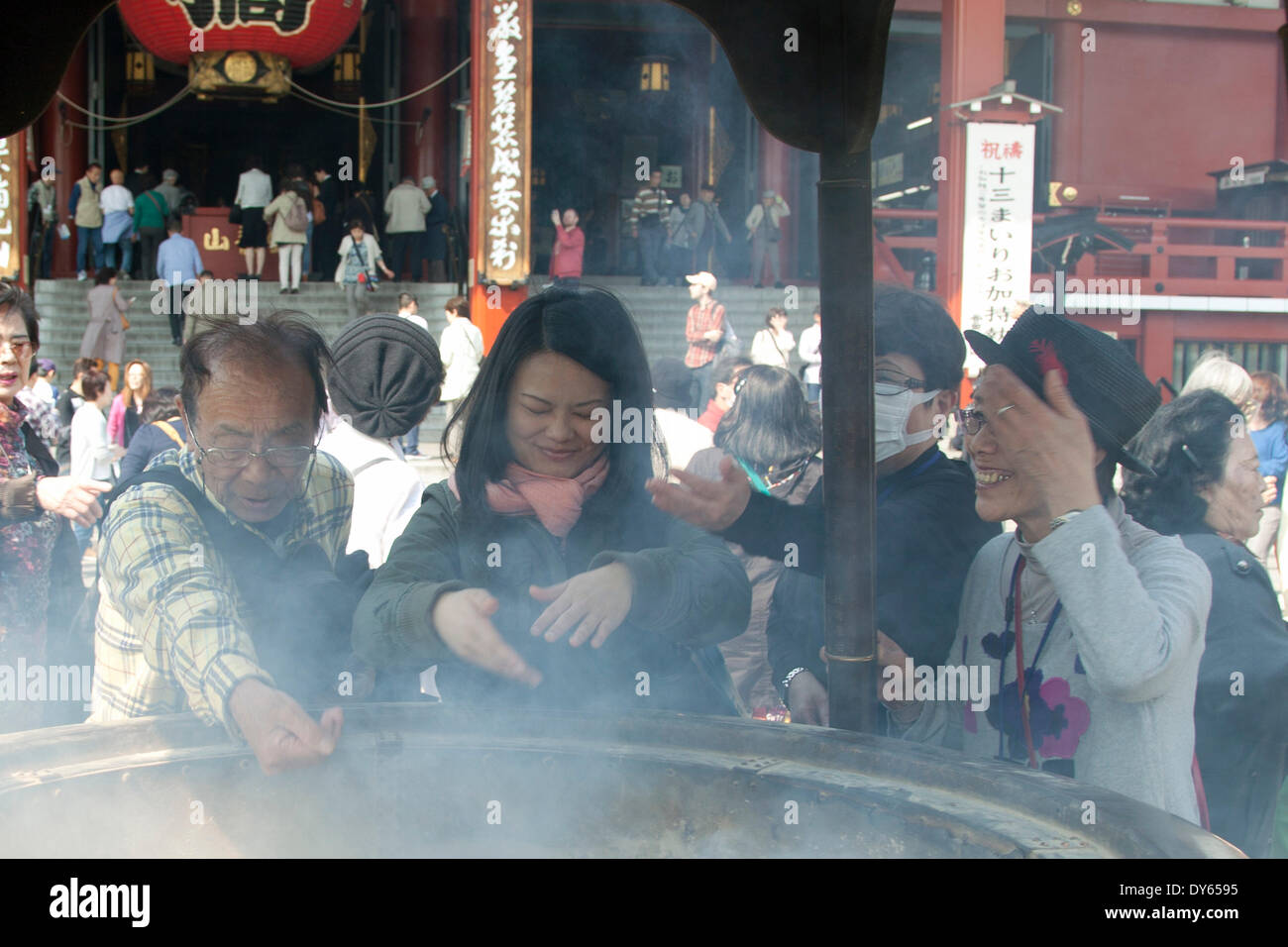 Tokyo, Japan - Worshippers throw themselves smoke to award off evil ...