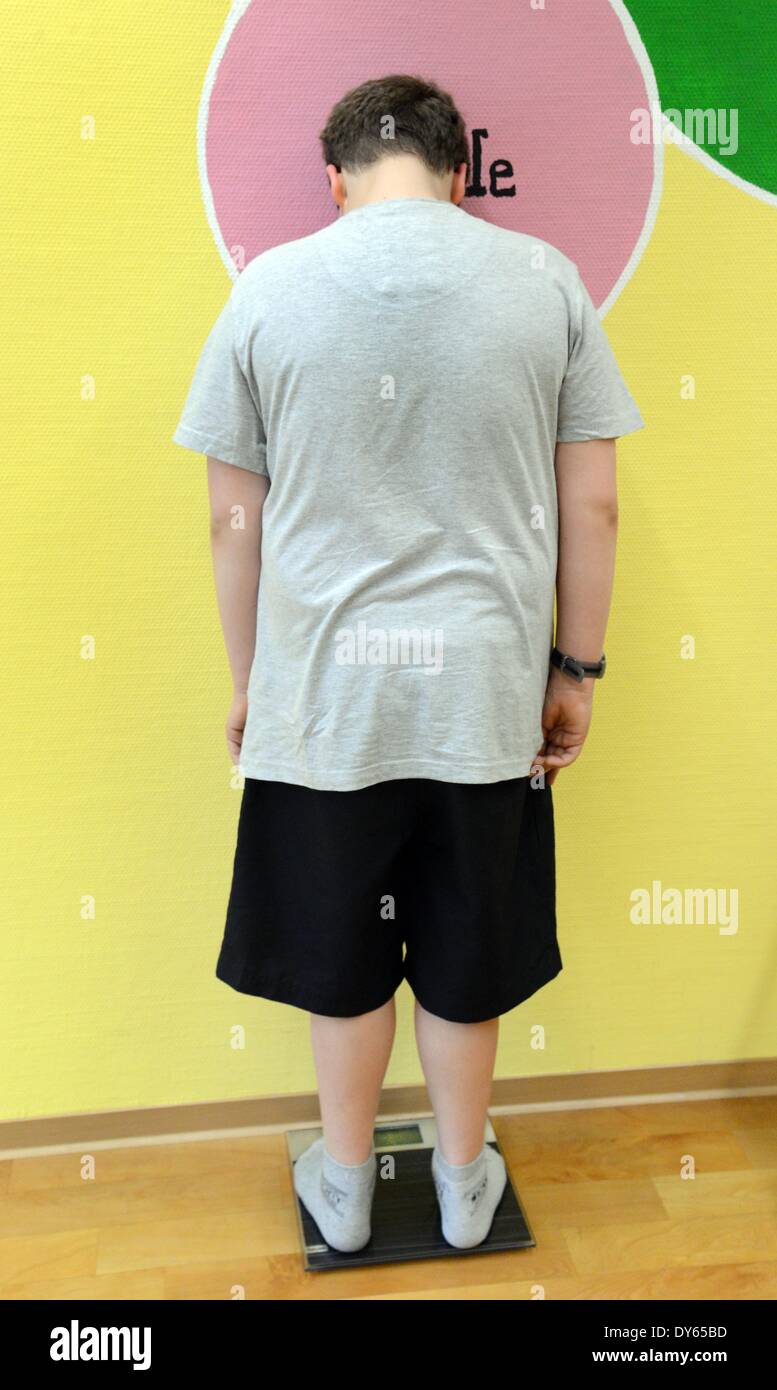 Overweight boy Jan takes his weight after an exercise class of the ...