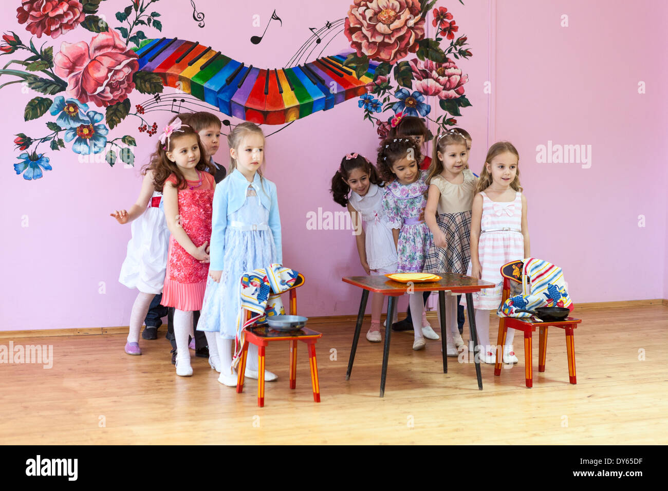 Boys and girls play in pairs on theater stage in kindergarten, Russia ...