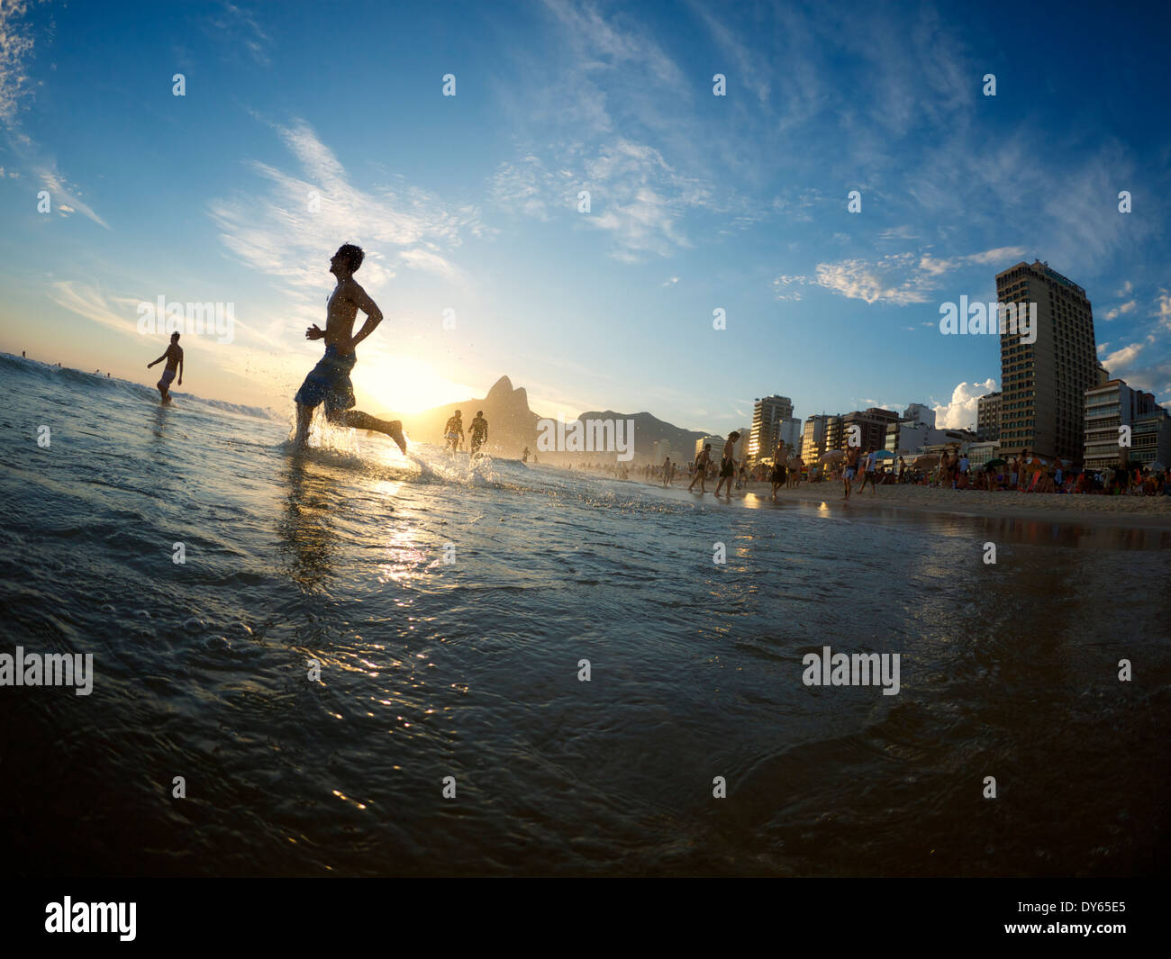 Silhouette of person running in the surf Ipanema Beach Rio de Janeiro ...