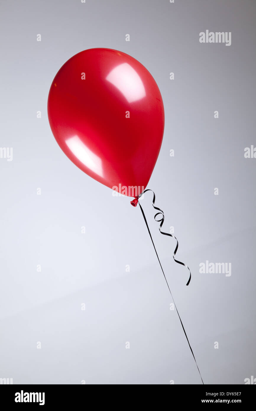 Shiny Red Balloons on a grey background Stock Photo - Alamy